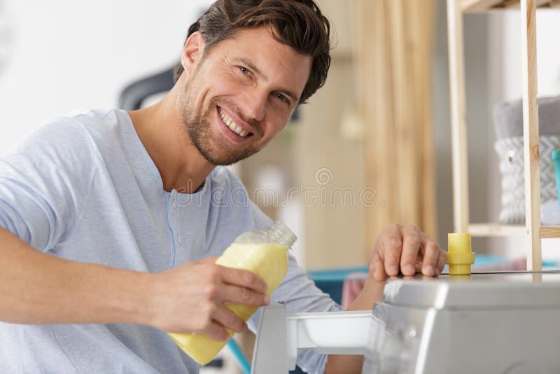 Happy man doing laundry stock photo. Image of twenties - 218002074