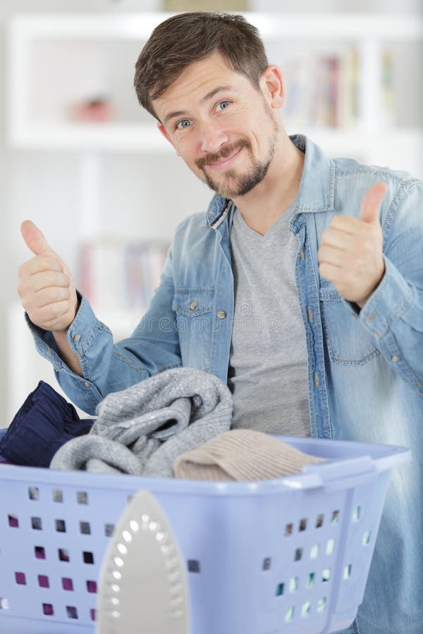Happy man doing laundry stock photo. Image of caucasian - 223325720