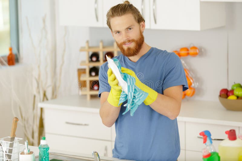Happy man doing washing up stock photo. Image of adult - 196367032