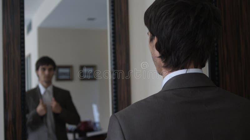 Young Businessman Dressing Himself in Front of Mirror. Stock Photo ...