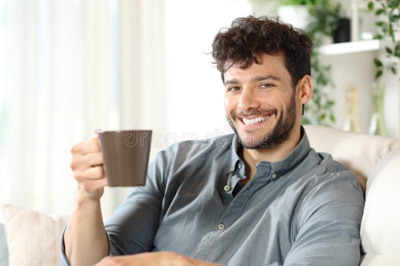 Happy Man Drinking Coffee at Home Looking at Camera Stock Image - Image ...