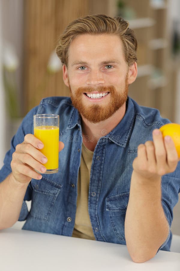 Happy Man Drinking Orange Juice Stock Photo - Image of ...