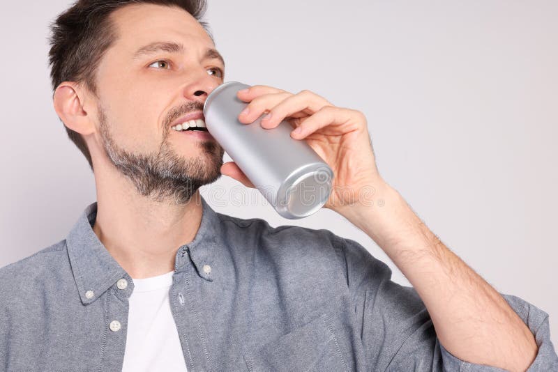 Happy Man Drinking from Tin Can on White Background Stock Image - Image ...