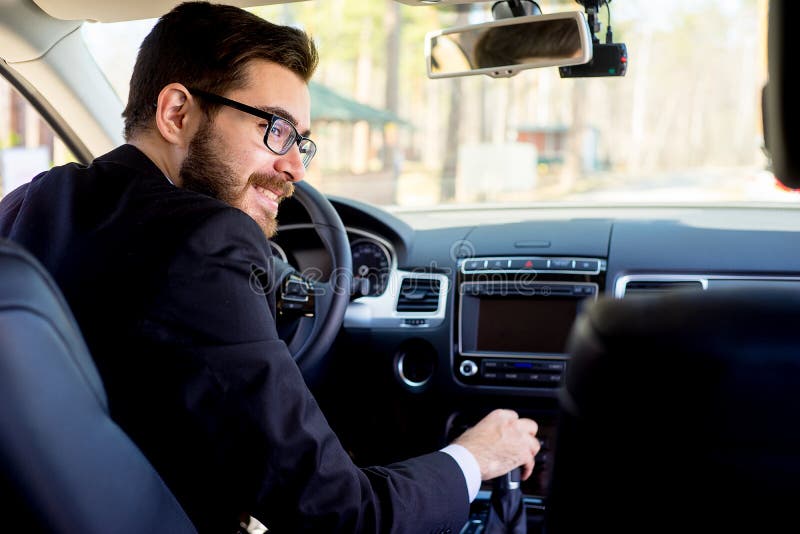 Happy man driving a car stock image. Image of retail - 94684123