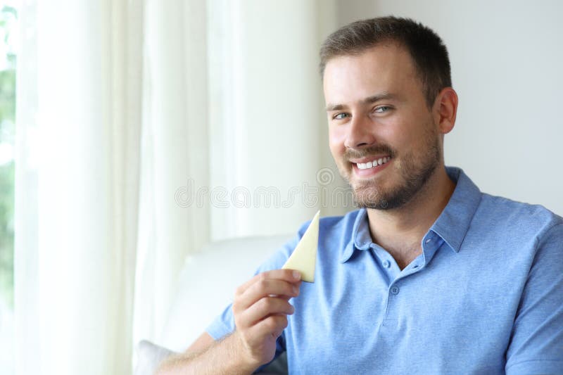 Happy Man Eating Cheese Looking at Camera Stock Photo - Image of hand ...
