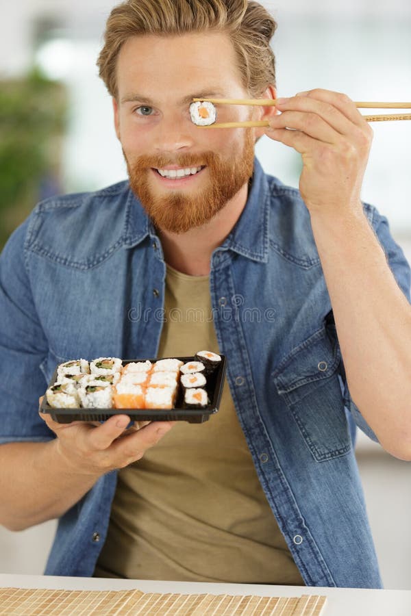 Happy man eating sushi stock image. Image of japanese - 165449771