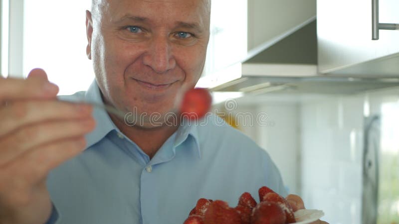Happy Man Eating Tasty and Flavored Strawberry with a Fork Stock Photo ...