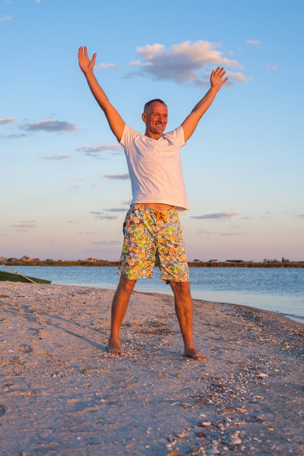 Happy Man on the Seashore, Enjoying Life during Sunrise Stock Image ...