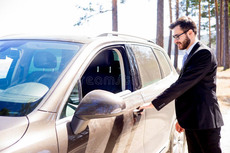 Happy man entering his car stock image. Image of handsome - 94683487