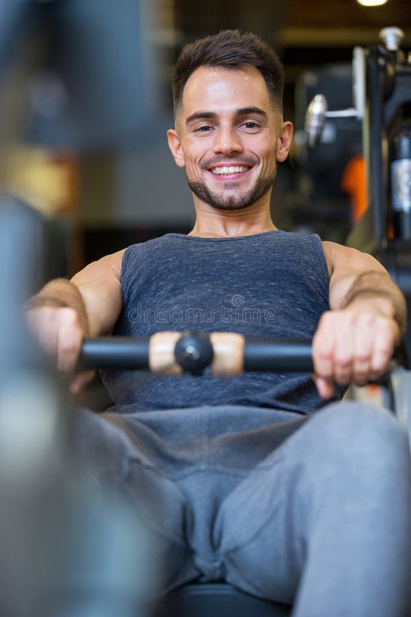 Happy Man Exercising on Rowing Machine Stock Image - Image of single ...