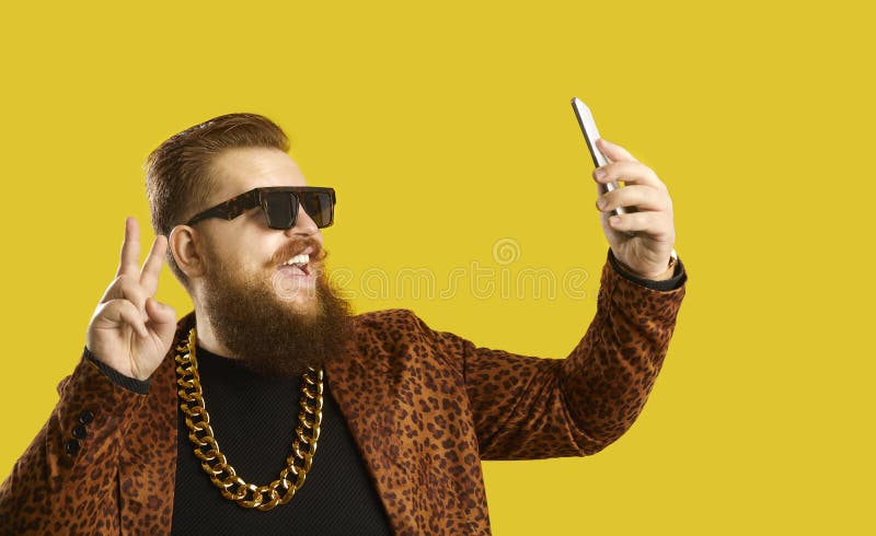 Happy Man in an Extravagant Outfit Taking a Selfie or Live Streaming on ... Happy Man in an Extravagant Outfit Taking a Selfie or Live Streaming on ...