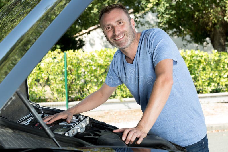 Happy man fixing car stock image. Image of broken, automobile - 258797193