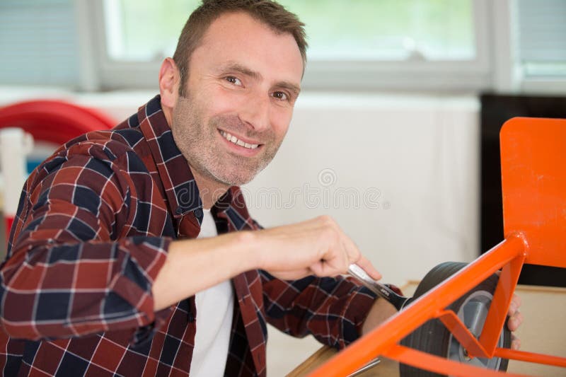 Happy Man Fixing Trolley Wheels Stock Photo - Image of idea, machine ...