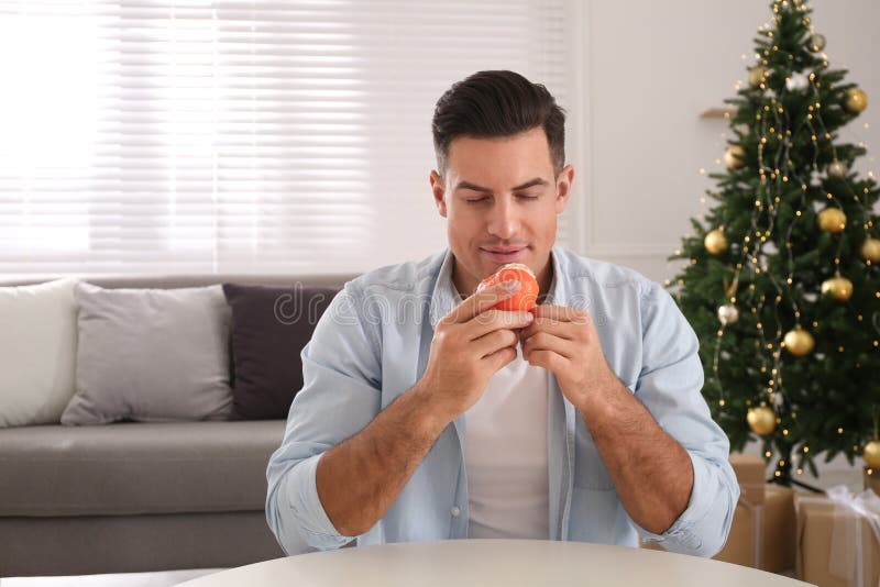 Happy Man with Fresh Tangerine at Table in Room Stock Image - Image of ...