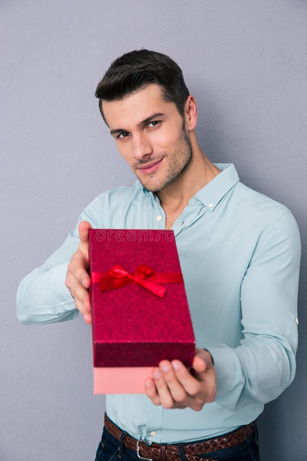 Happy Man Giving Gift Box on Camera Stock Image - Image of smile ...