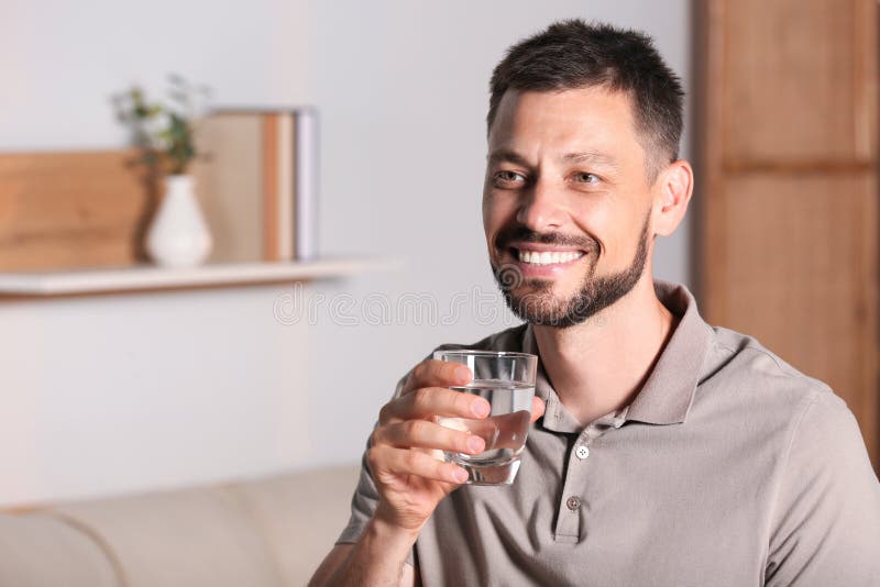 Happy Man with Glass of Water Indoors. Refreshing Drink Stock Image ...