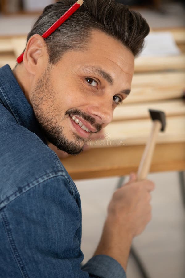 Happy man hammering nail stock image. Image of closeup - 272191923