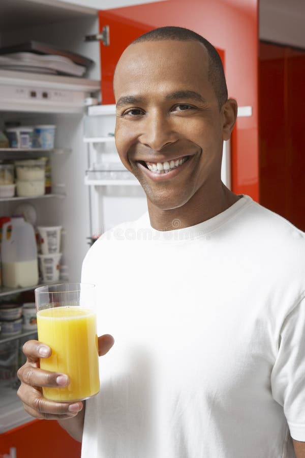 Mid Adult Man Holding a Glass of Orange Juice Stock Image - Image of ...