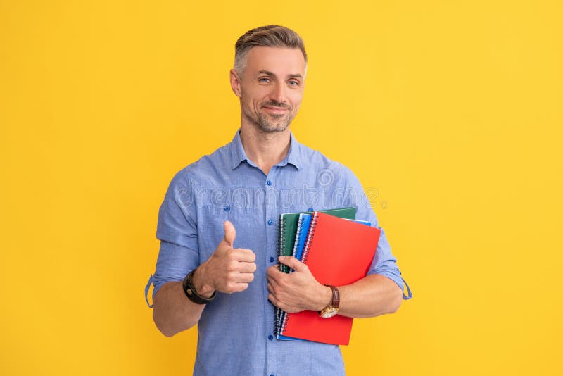 Happy Man Hold School Notebook Or Planner Showing Thumb Up Education