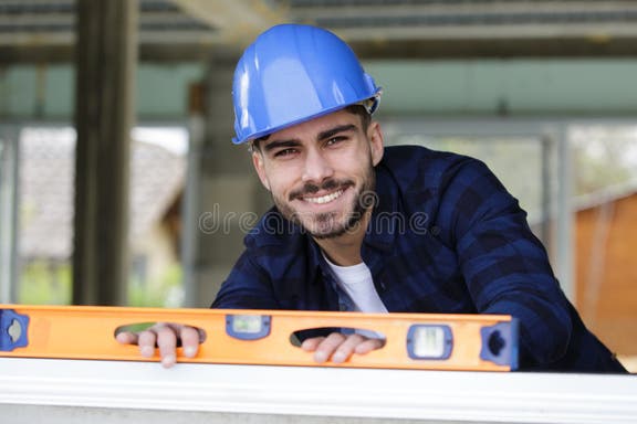 Happy Man Holding Building Level Stock Photo - Image of group ...
