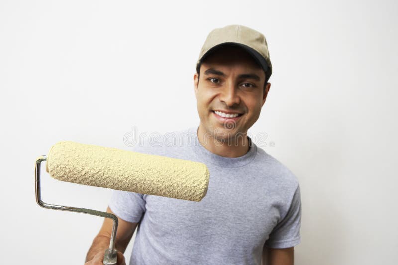 Happy Man Holding Roller Paint Stock Photo - Image of people, indoor ...