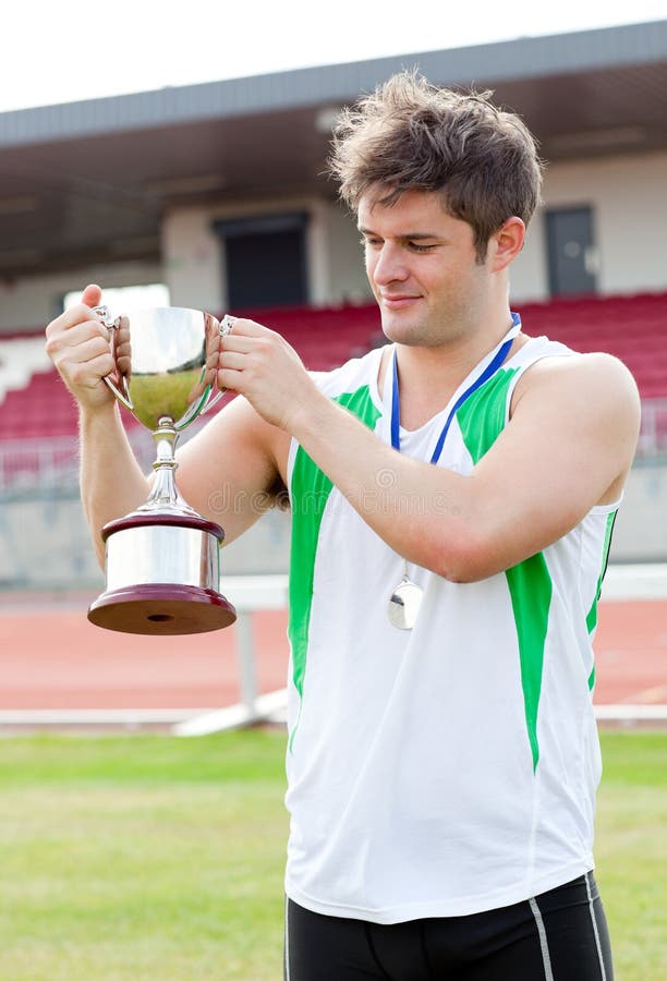 Happy man holding a trophy stock photo. Image of sport - 16093362