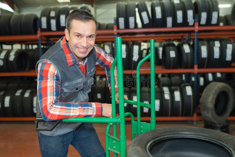Happy Man Holding Tyre at Maintenance Point Stock Image - Image of ...