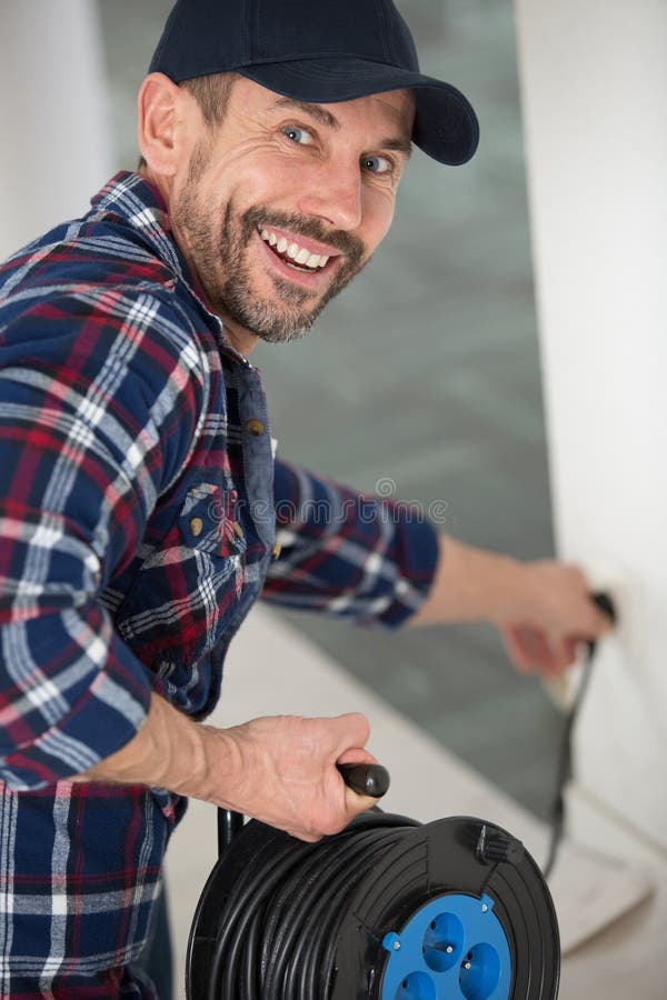 Happy Man Holds Electric Plug and Long Cable Stock Image - Image of ...