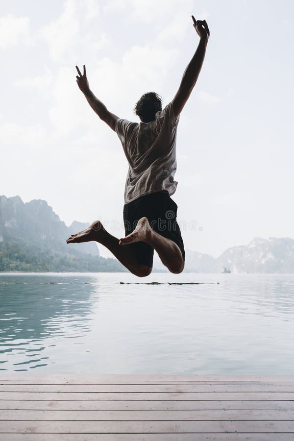 Happy man jumping with joy stock photo. Image of lifestyle - 116369768