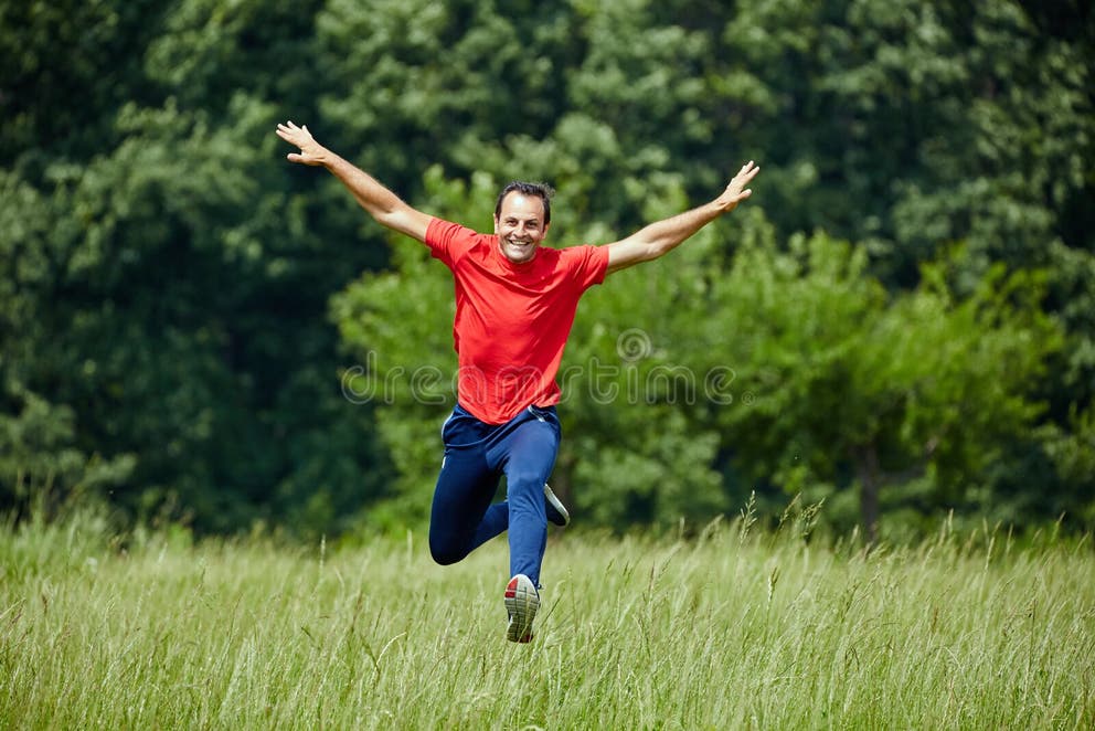 Happy man jumping for joy stock image. Image of outside - 94637427