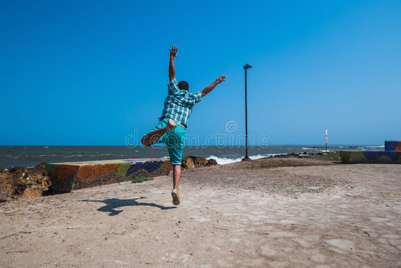 A Happy Man Jumping Up in the Air in a Park. Retired Concept Stock ...
