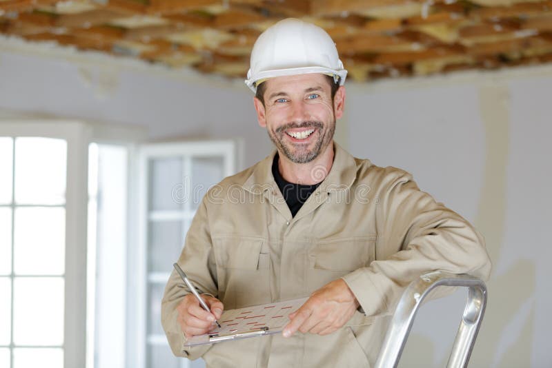 Happy man on ladder stock image. Image of professional - 148582745