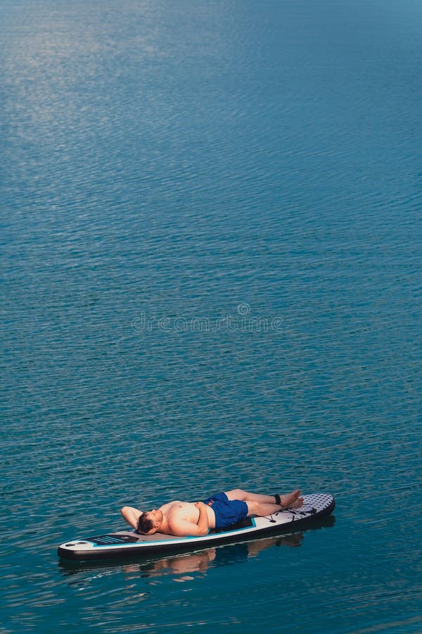 Happy Man Lays Down on Supboard Sunbathing Stock Image - Image of bank ...