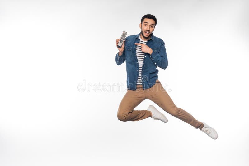 Happy Man Levitating while Pointing at Stock Image - Image of pants ...