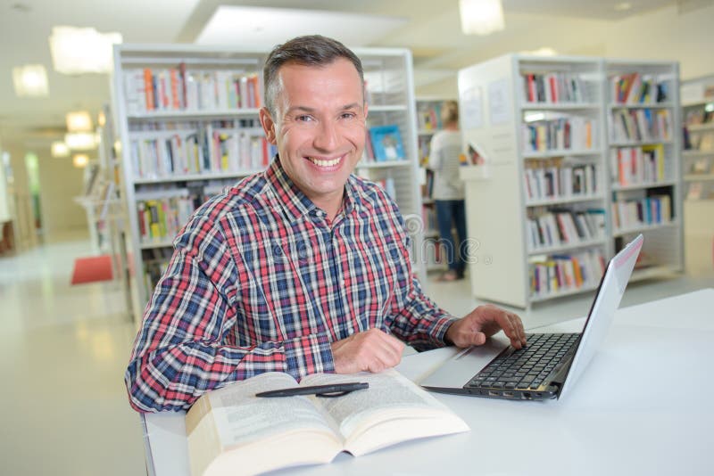 Happy man in library stock image. Image of write, research - 223326407
