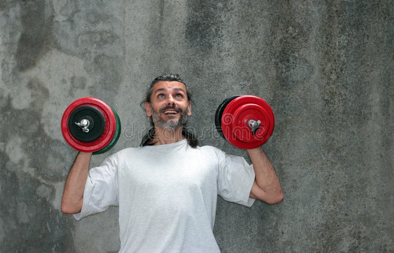 Happy man lifting dumbbell stock photo. Image of smile - 25249902