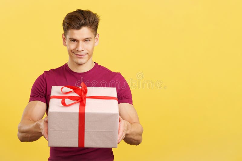 Happy Man Looking at the Camera Giving a Present Stock Image - Image of ...