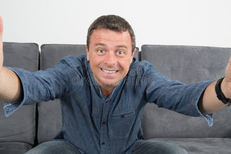 Happy man making a selfie stock photo. Image of sofa - 61812472