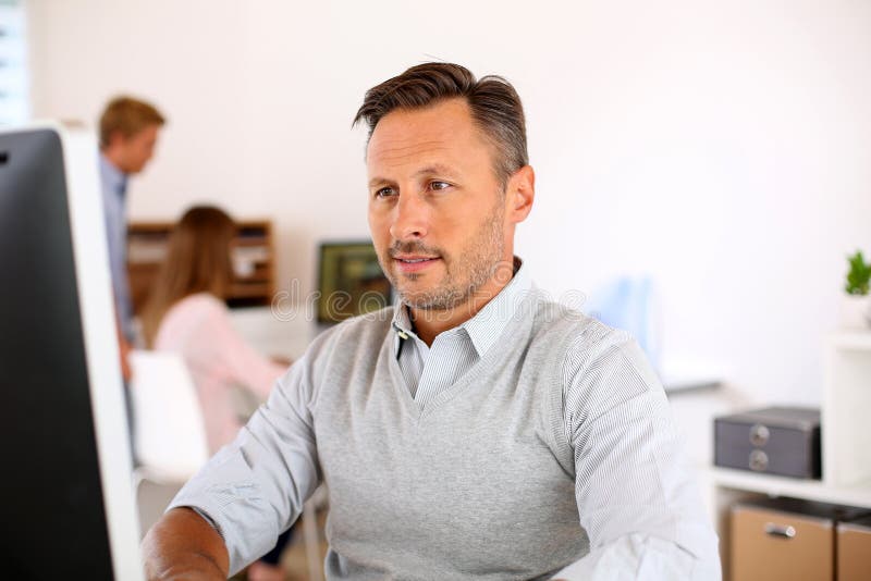 Happy Man in Office Sitting in Front of Computer Stock Image - Image of ...