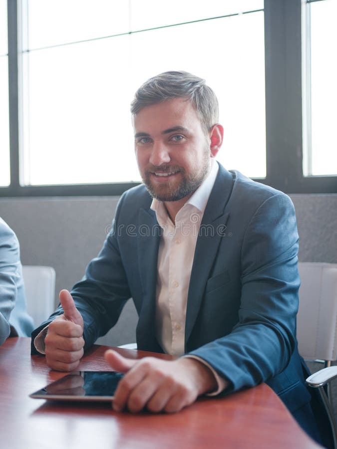 Happy Man in the Office Sitting and Posing on the Camera . Business ...