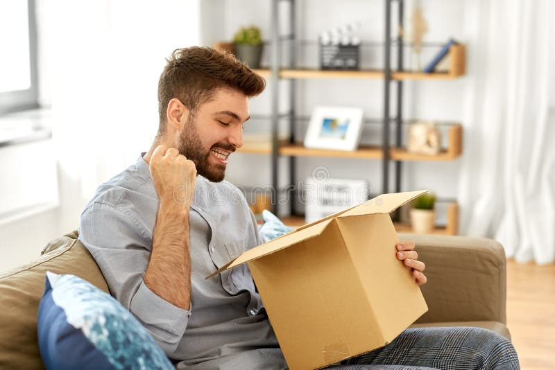 Happy Man Opening Parcel Box at Home Stock Image - Image of cardboard ...