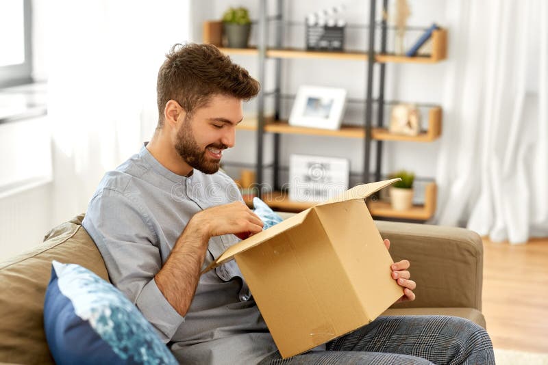 Happy Man Opening Parcel Box at Home Stock Photo - Image of people ...