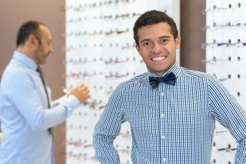 Happy man in optic store stock image. Image of young - 281913449