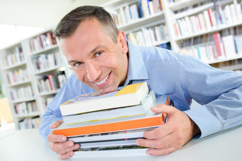 Happy man and pile books stock photo. Image of addiction - 261511590