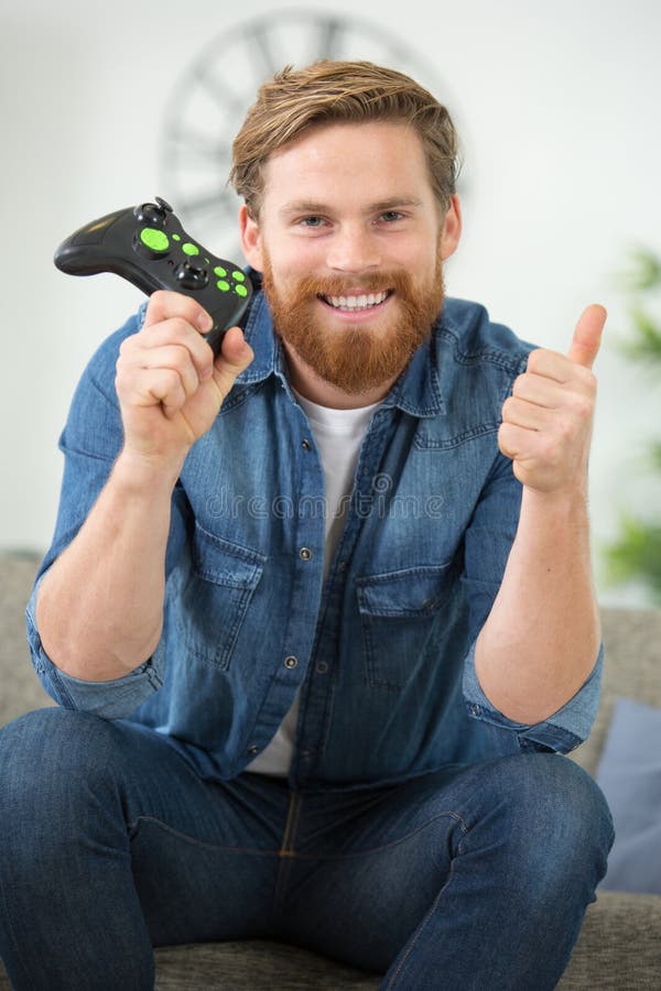Happy Man Playing Games at Home Showing Thumb-up Stock Photo - Image of ...