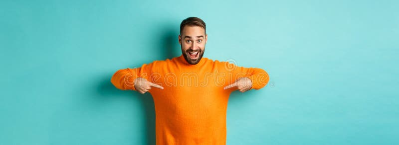 Happy Man Pointing At Sweater Showing Your Logo Banner On Clothes