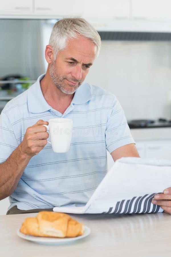 Happy Man Reading the Newspaper at Breakfast Stock Image - Image of ...