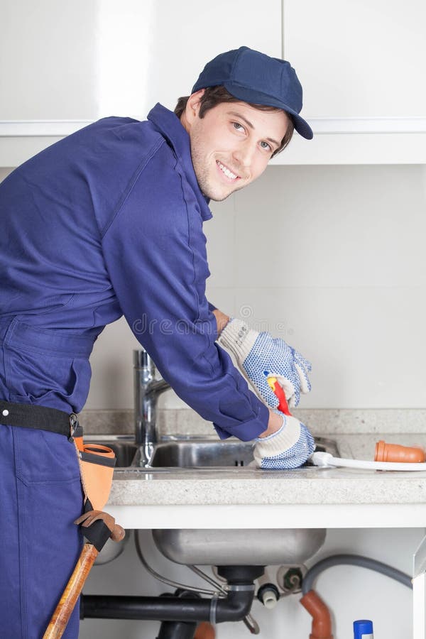 Plumber doing a good job stock photo. Image of holding - 74304020