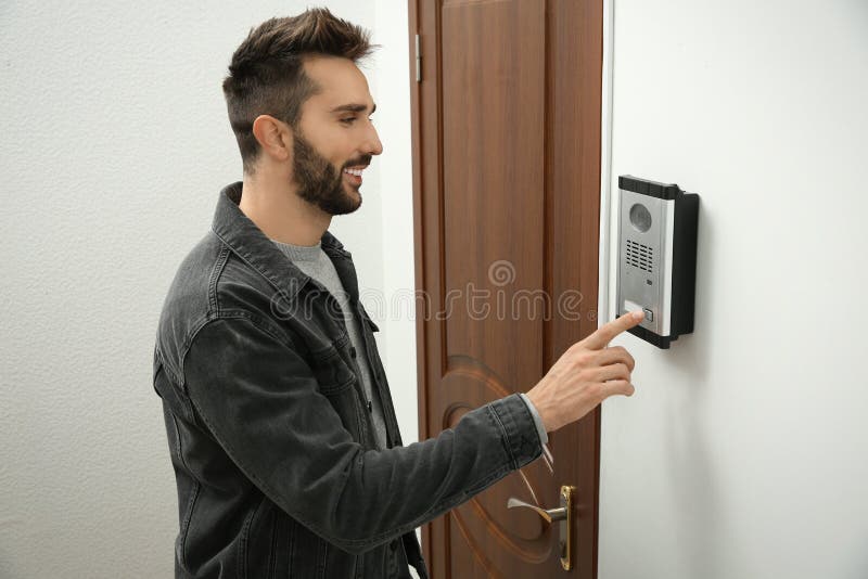 Happy Man Ringing Intercom with Camera in Entryway Stock Image - Image ...