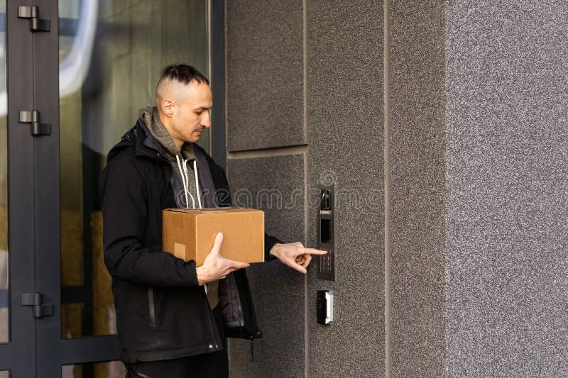 Happy Man Ringing Intercom with Camera in Entryway. Stock Image - Image ...